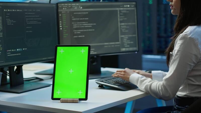 Software Developer In Data Center Monitoring Security Threats Using Mockup Tablet It