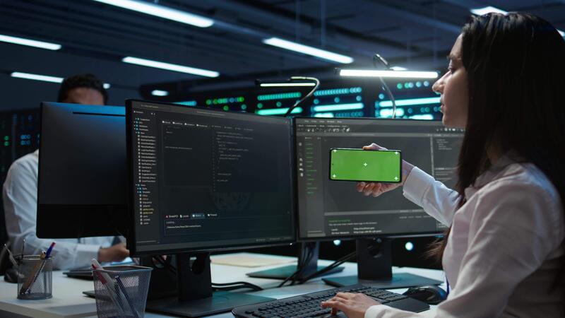 Technician Using Mockup Mobile Phone In Data Center Managing Servers
