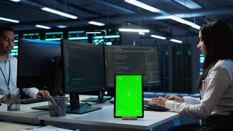 Software Developer In Data Center Monitoring Security Threats Using Mockup Tablet It