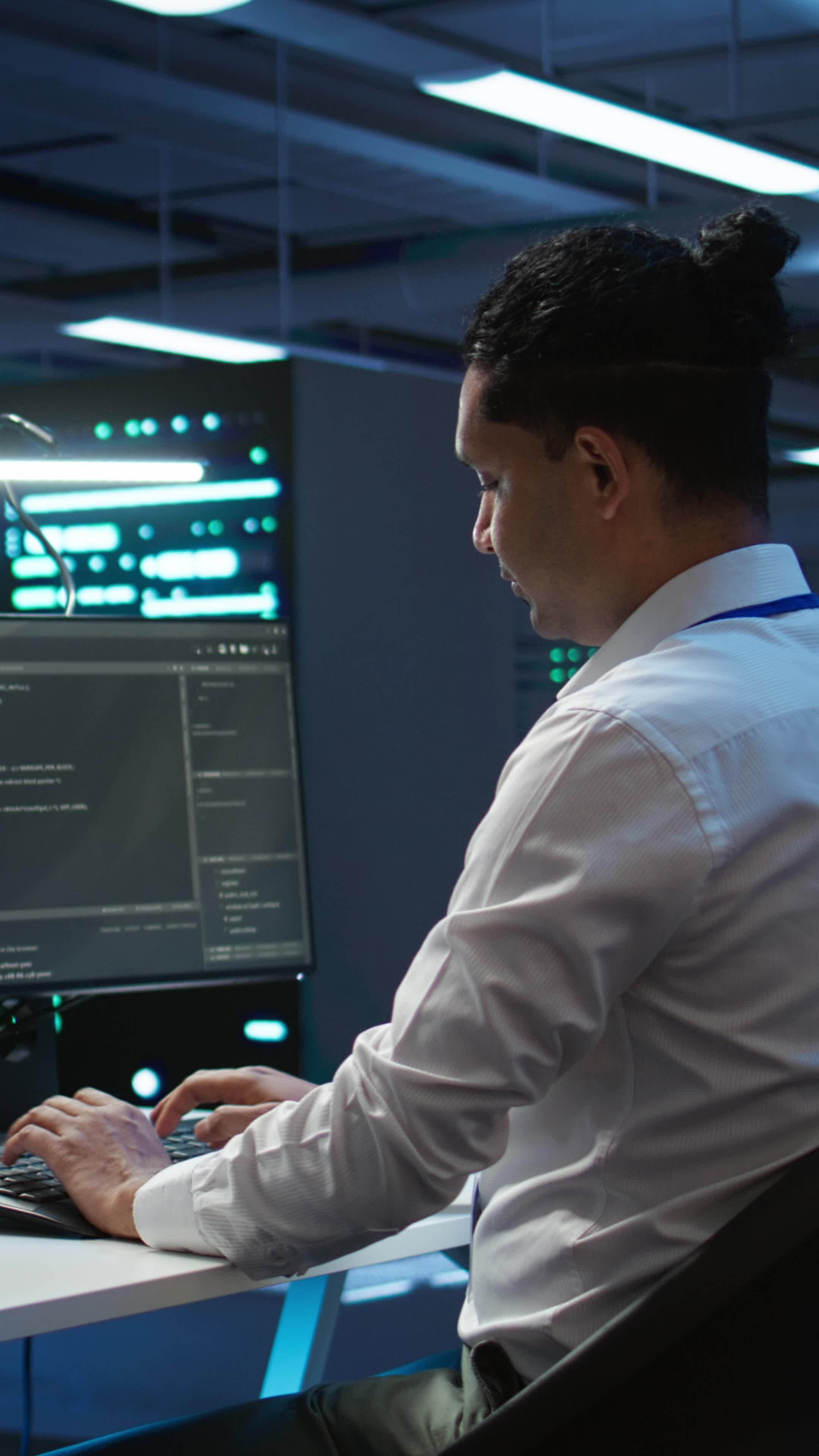 Vertical Engineers in high tech data center establishment installing software on computer ...