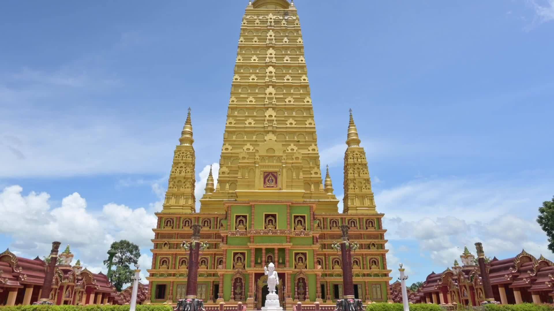 Spectacular scene of a great golden pagoda in buddhist temple with idyllic cloudy blue sky. Wat ...