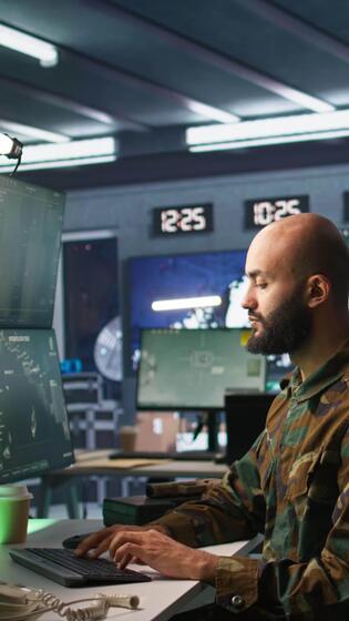 Vertical Military Agent Working In Control Room Analyzing Aerial Reconnaissance Data
