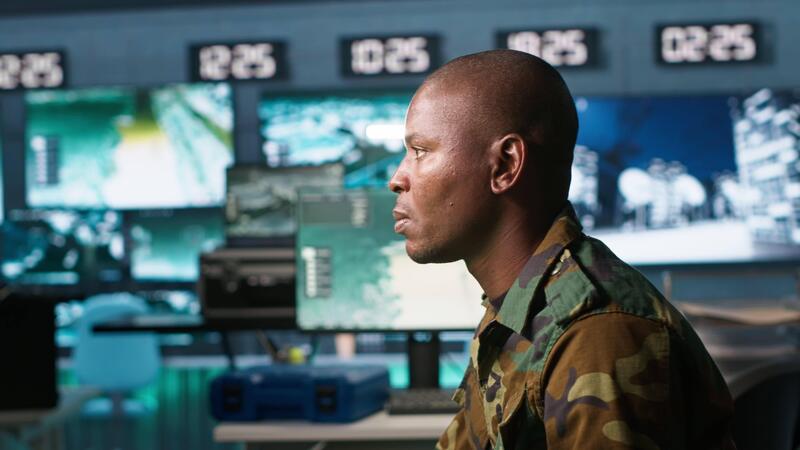 Portrait Of Military Agent Working In Control Room Analyzing Aerial Reconnaissance Data