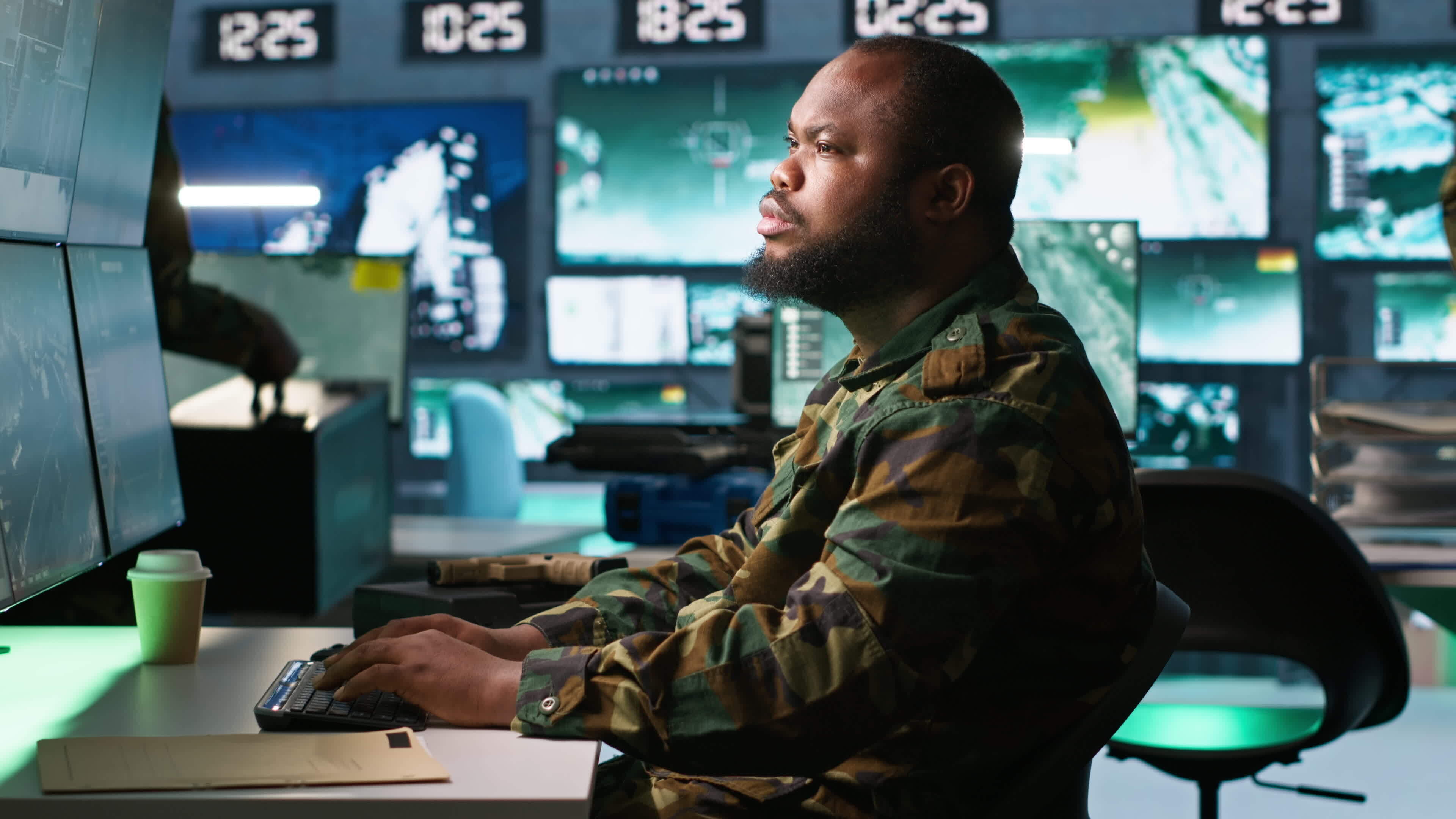 Officer in command center helped by colleague to plan, analyze and ...