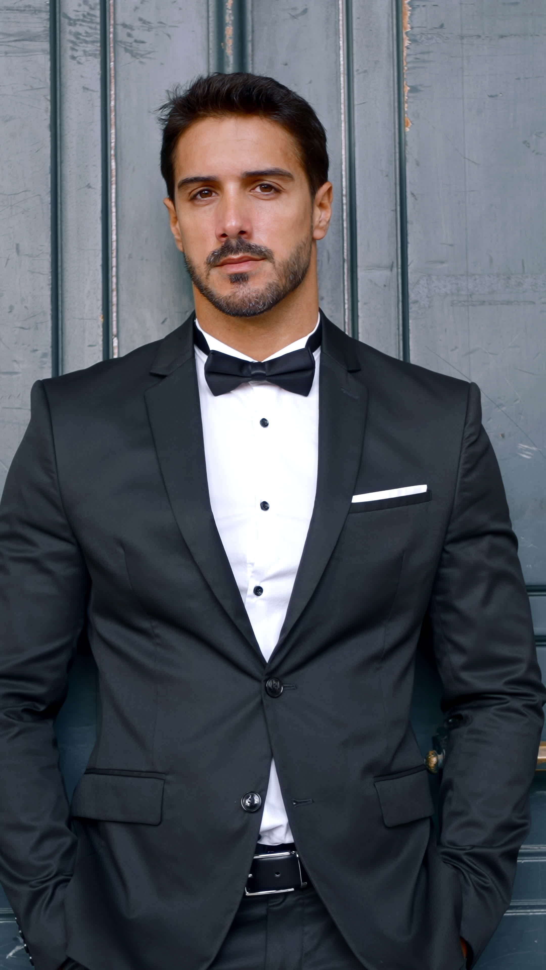 Gorgeous man in suit is standing. Action. Attractive young man in ...