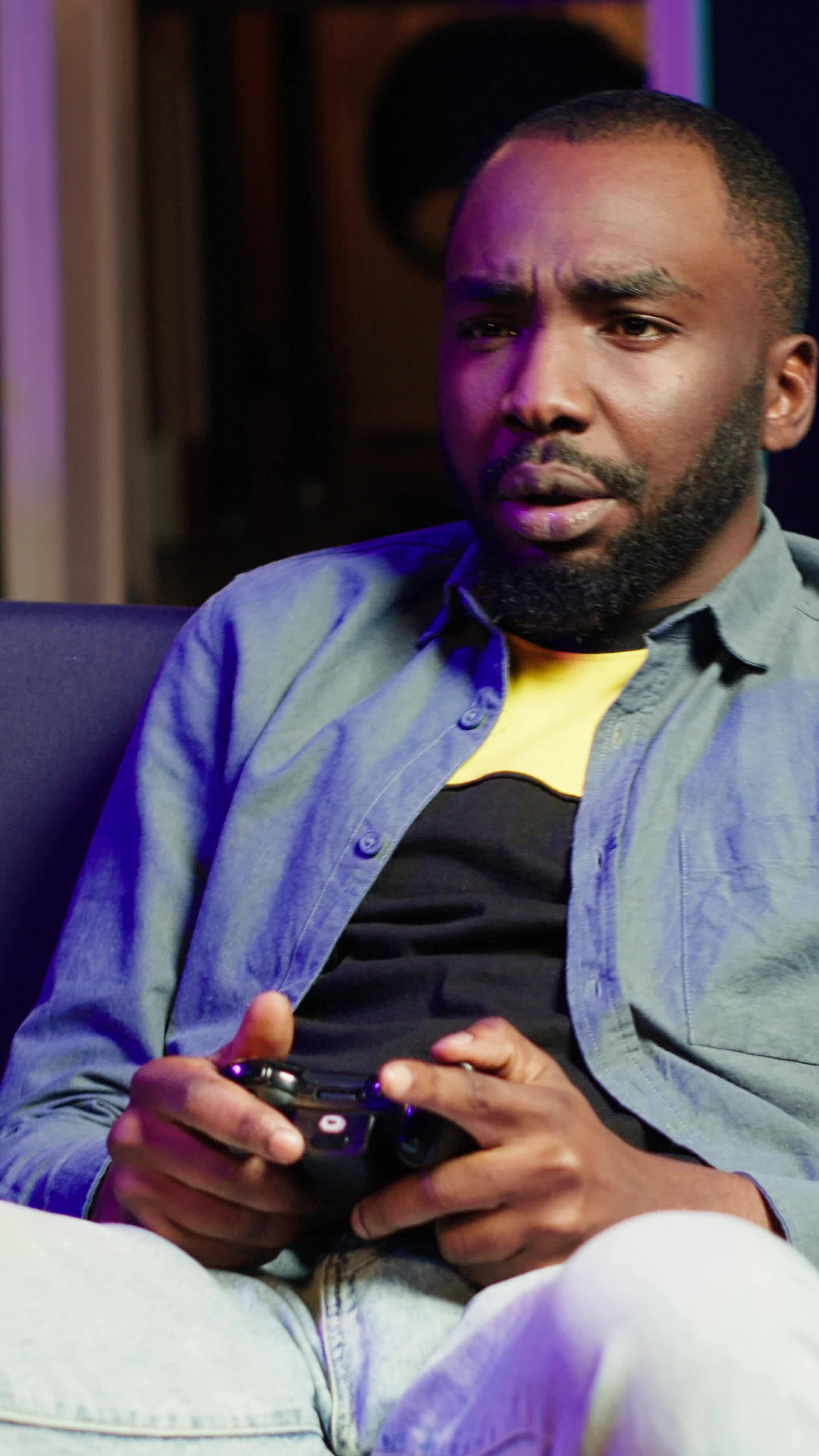 Vertical Gamer Upset After Losing While Playing Videogames On Console System Using Controller