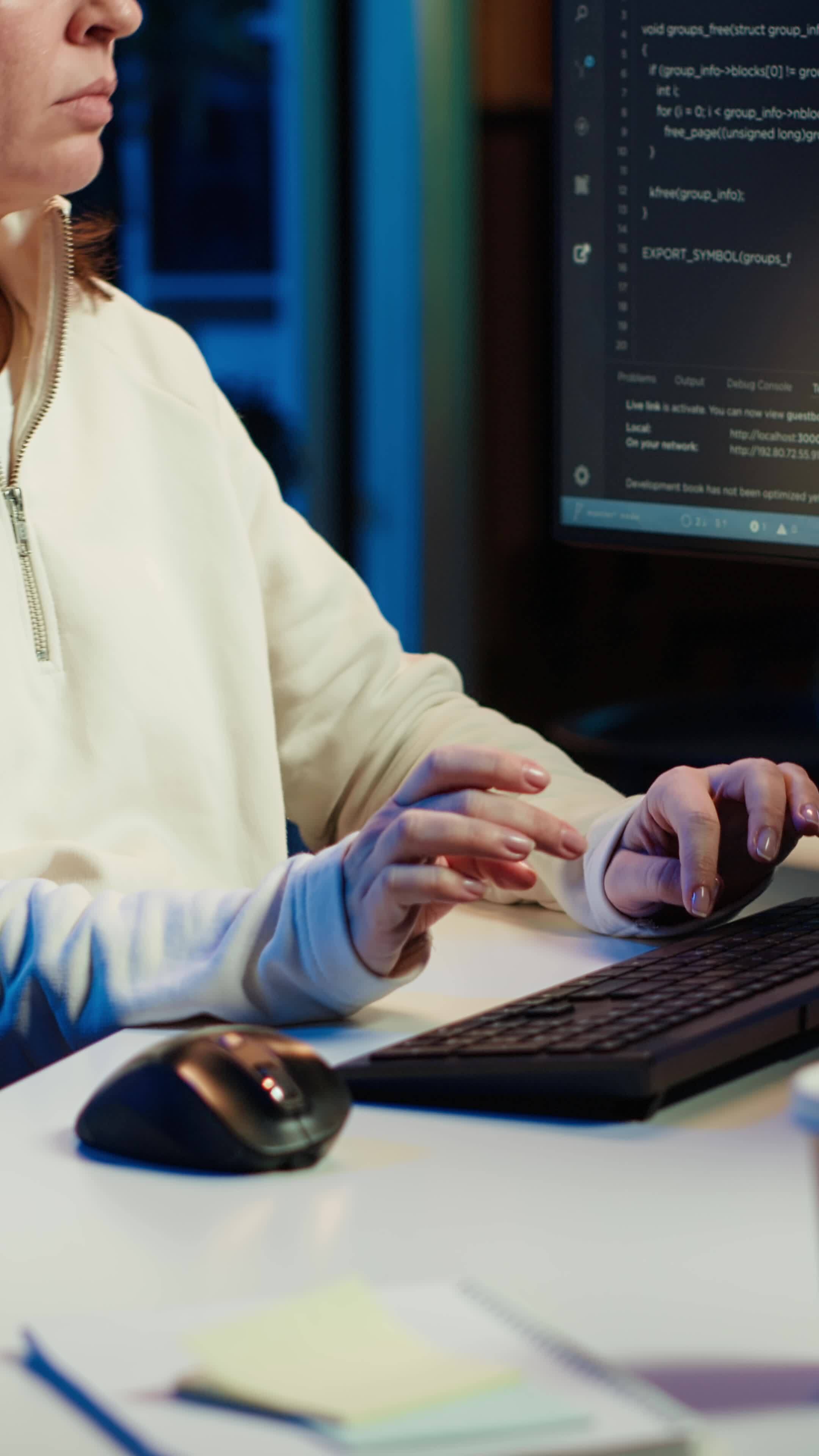 Vertical IT programmer listening music while fixing vulnerabilities in software compromising ...