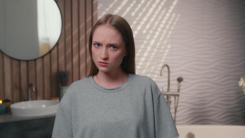 Female portrait in home bathroom sad displeased offended woman ...