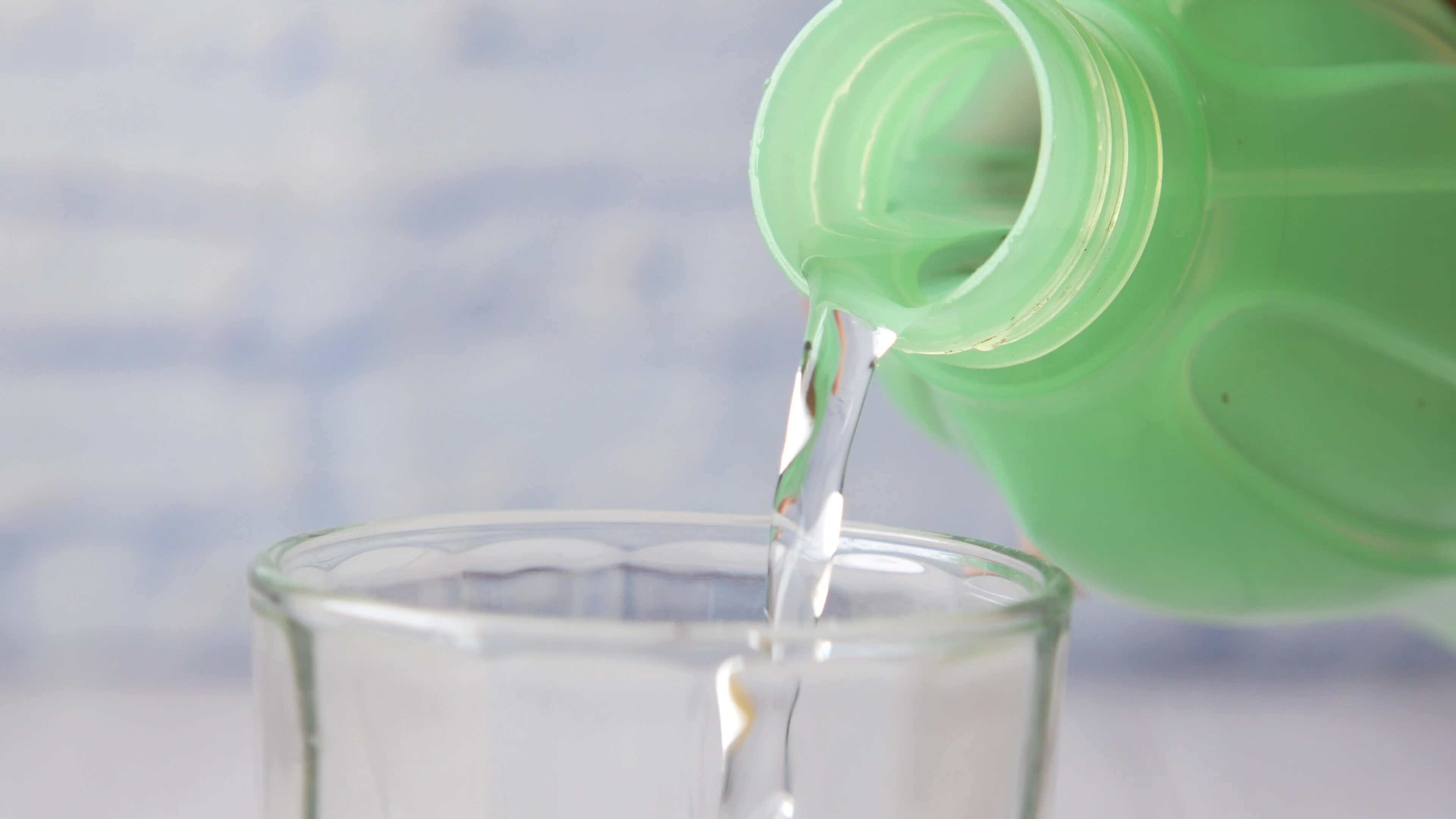 A green bottle pouring water into a glass 49851819 Stock Video at Vecteezy