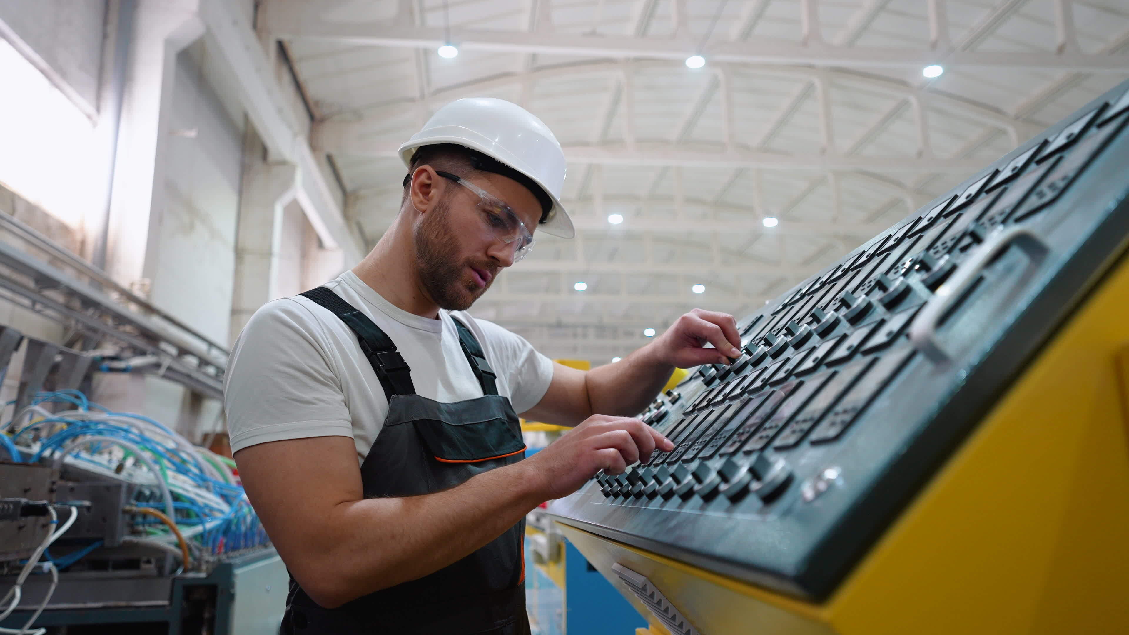 Worker On Factory Analyzes The Production Process And Programming Industrial CNC Machine Tool ...