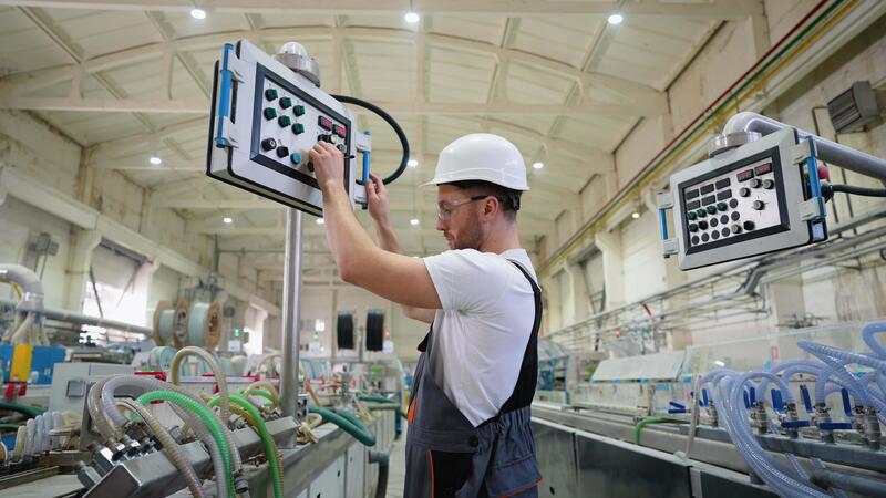 Worker On Factory Analyzes The Production Process And Programming Industrial CNC Machine Tool ...