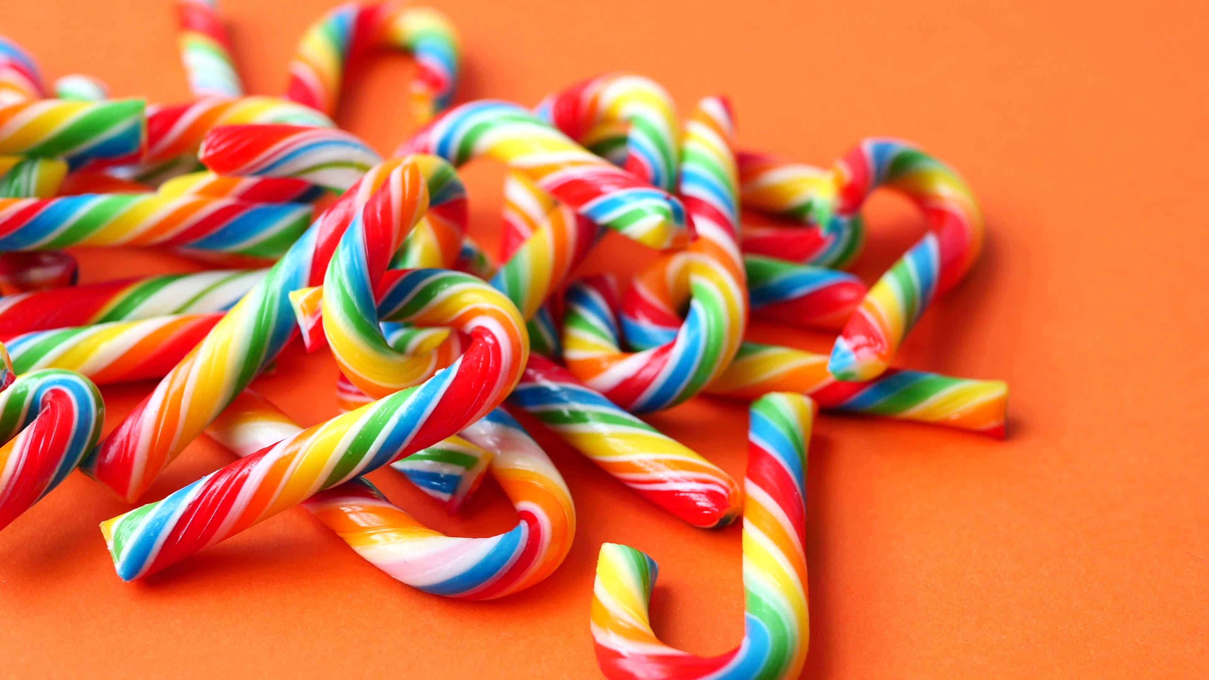 A pile of colorful candy canes on an orange background 50499108 Stock ...