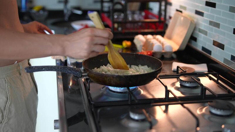 The Cooking Process in a Modern Kitchen, Emphasizing the Importance of Stirring Food Thoroughly ...