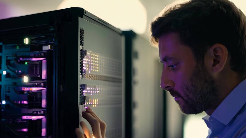 IT specialist fixing server rack glowing LED engineer system ...