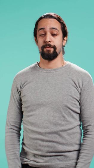 Vertical Man shrugging shoulders, unable to provide answer, having ...