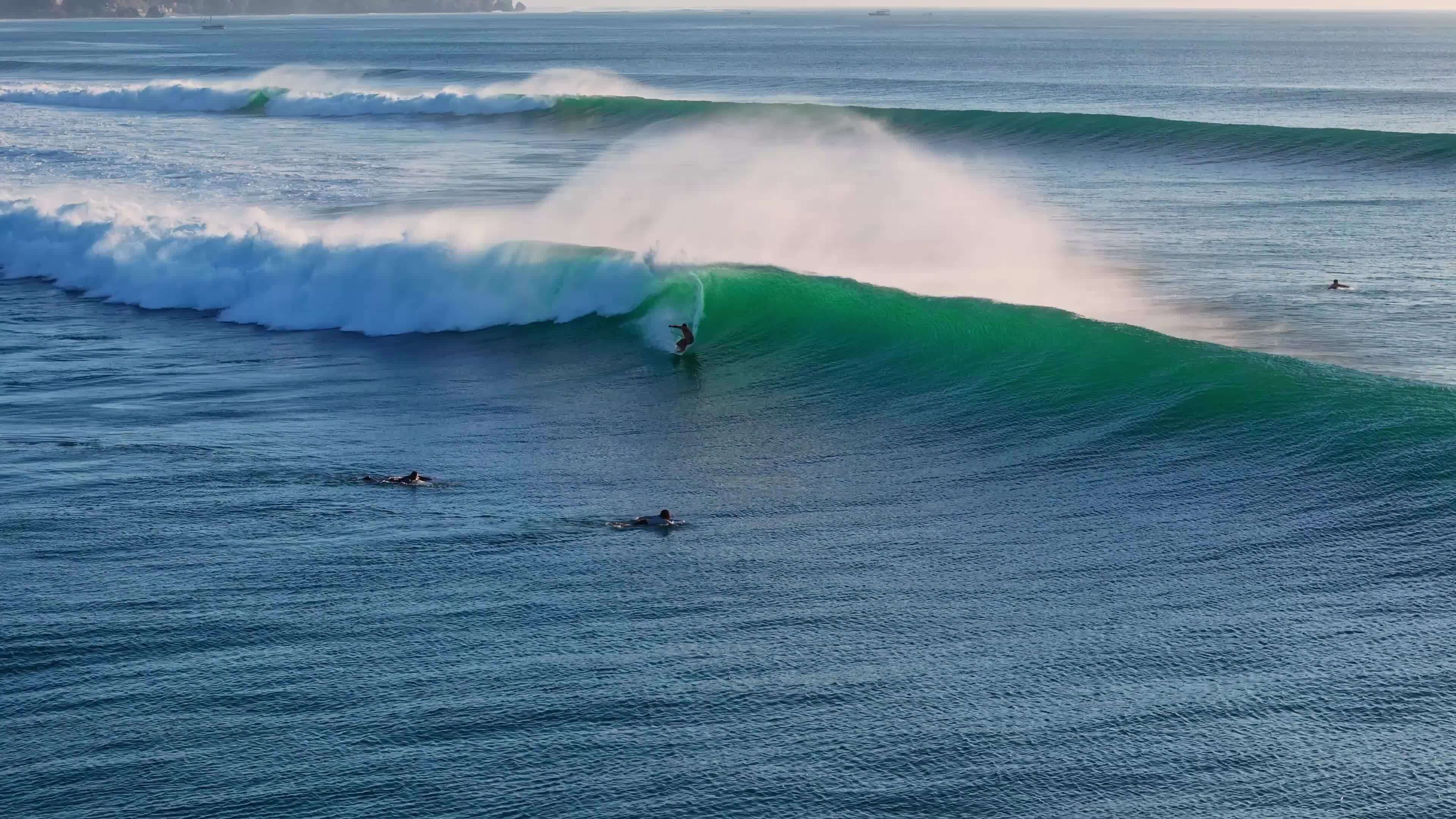 Perfect waves with surfers at Bali. Drone view of surfing. Surfer ride ...