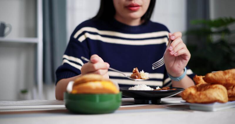 Handheld Selective Focus Shot Happy Asian Woman Eating Rice At Dining