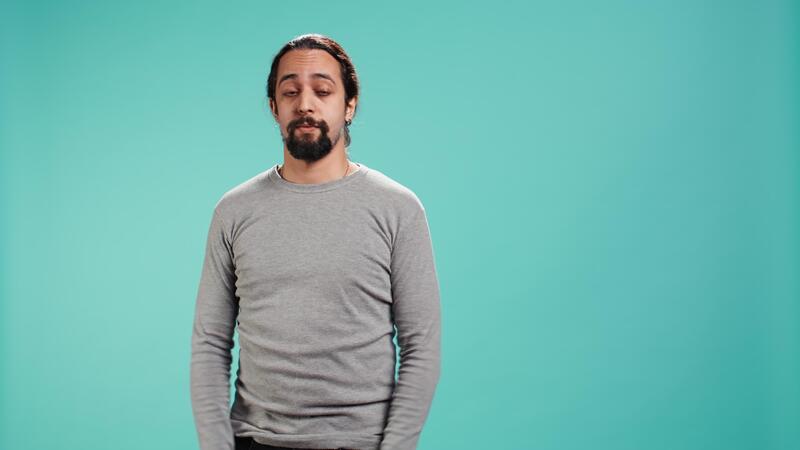 Man shrugging shoulders, unable to provide answer, having detached ...