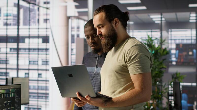 Programmer And Colleague Conducting Experiments And Tests To Optimize Machine Learning Models