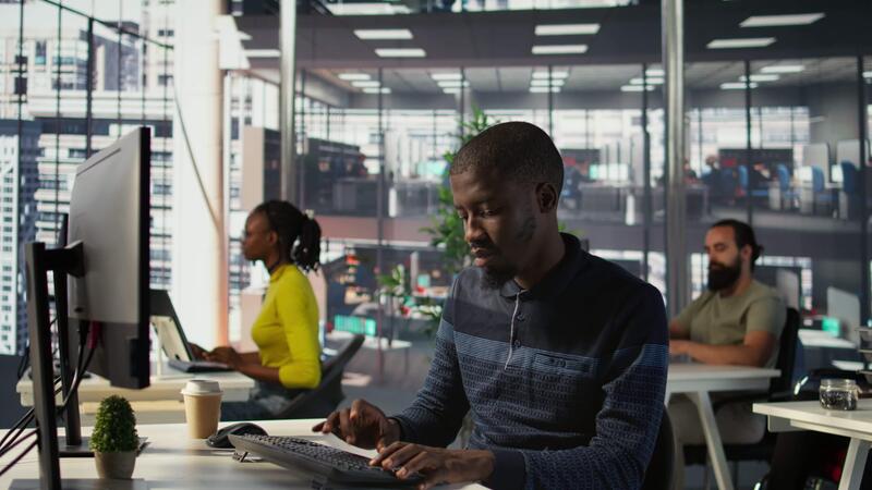 Programmer Doing Software Debugging Asking For Help From Smiling Team Leader In Wheelchair