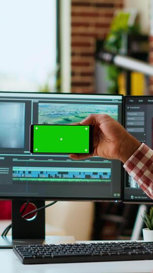 Vertical Male Filmmaker Editing A Project In A Modern Color Grading Software Using Copy Space