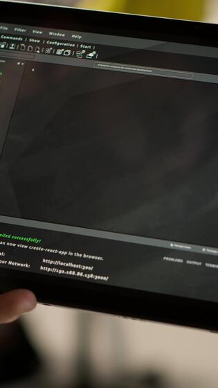 Vertical Software Engineer Using Tablet To Design Algorithms That
