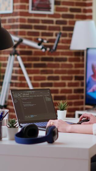 Vertical Software Developer Types Programming Code In A Cozy Home