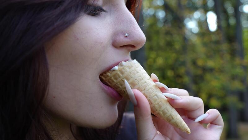 Captured In A Close Up A Young Girls Happy Expression Radiates As She Seductively Licks Ice