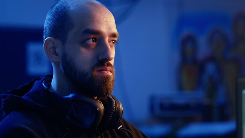 Hacker Hiding In Underground Bunker Looking Over His Shoulder And