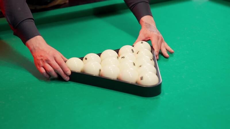 A person placing balls into a pool table 52880904 Stock Video at Vecteezy