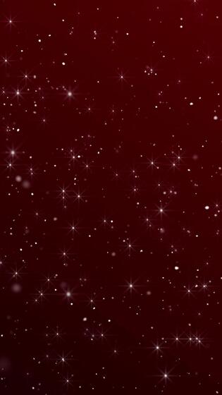 Shiny glittering red Christmas background with white twinkling stars and swirling snow particles ...