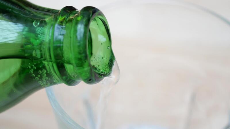 Pouring Sparkling Water Into a Glass from a Vibrant Green Bottle 54559212 Stock Video at Vecteezy