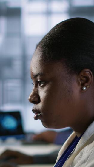 Vertical Close Up Of Programmer In Data Center Implementing Ai Predictive Maintenance Systems