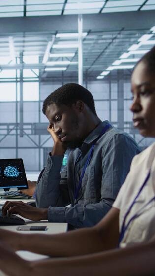 Vertical Tired data center engineer yawning, suffering from lack of ... Vertical Tired data center engineer yawning, suffering from lack of ...