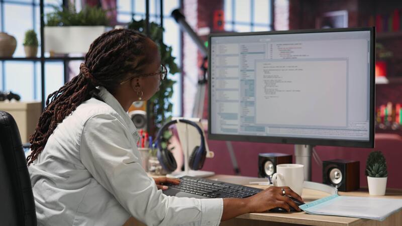 Engineer In Home Office Looks At Ui On Computer Monitor Typing And Executing Programming Code