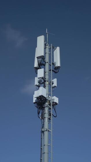 A Telecommunications Tower Equipped with Various Antennas Set Against a Clear Blue Sky 55459750 ...