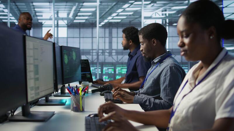 Engineers Seeing System Hacked Popup On Pc Screen In Data Center
