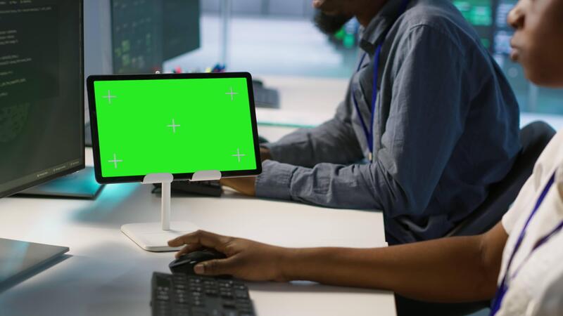 Team Of Programmer Using Green Screen Tablet Working In Server Farm To