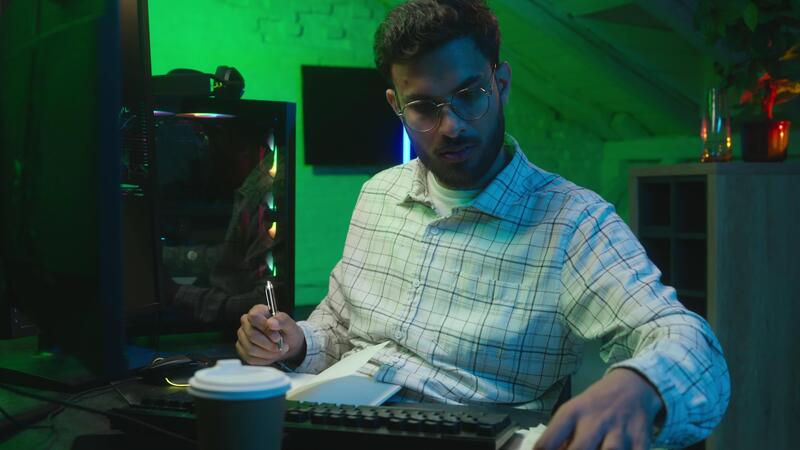 Arabian Indian man male guy programmer examining writing binary code ... Arabian Indian man male guy programmer examining writing binary code ...