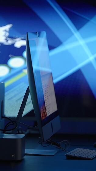 A Modern Computer Setup Featuring a Digital Background Alongside ...