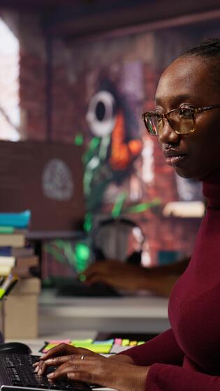 Vertical IT startup worker using large language model application to get help with coding tasks ...