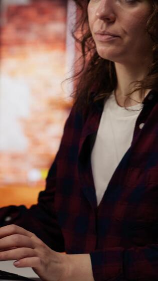 Vertical Employee Working In Innovative Startup Office Using Programming Languages To Build