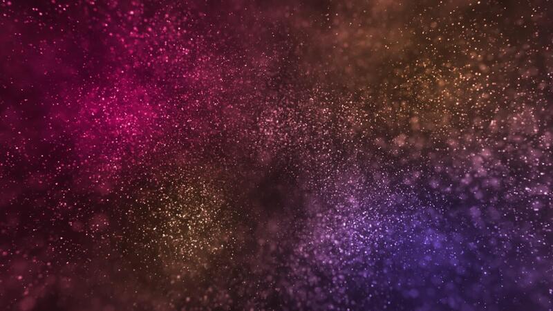 Abstract motion background with glittering shiny color particles and shallow depth of field ...