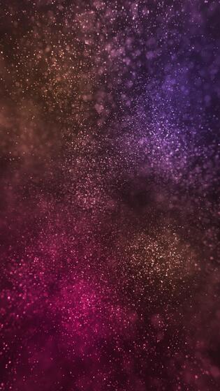Abstract motion background with glittering shiny color particles and shallow depth of field ...