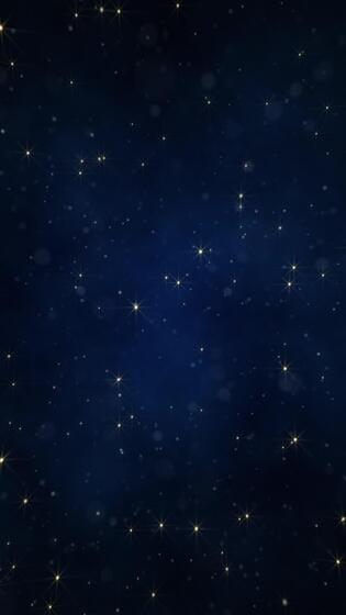 Bright shiny twinkling golden stars in the night sky moving towards the camera. This glittering ...