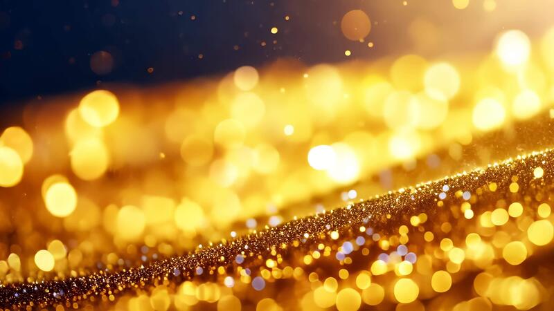 abstract Golden particles shimmering on a dark blue background, creating a magical dreamy bokeh ...