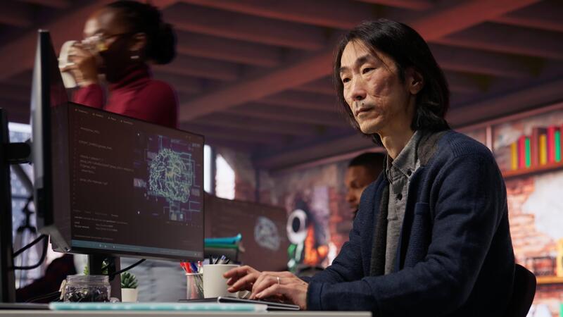 CTO manager in AI startup drinking coffee while coding applications in programming languages ...