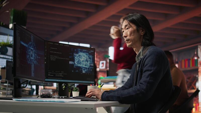 CTO manager in AI startup drinking coffee while coding applications in programming languages ...