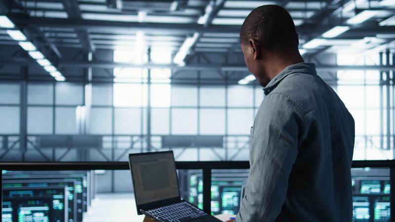 Engineer In Data Center Operating Notebook Deploying New Server