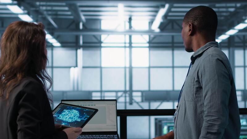 Teamworking Data Center Computer Scientists Using Artificial Intelligence On Laptop And Tablet